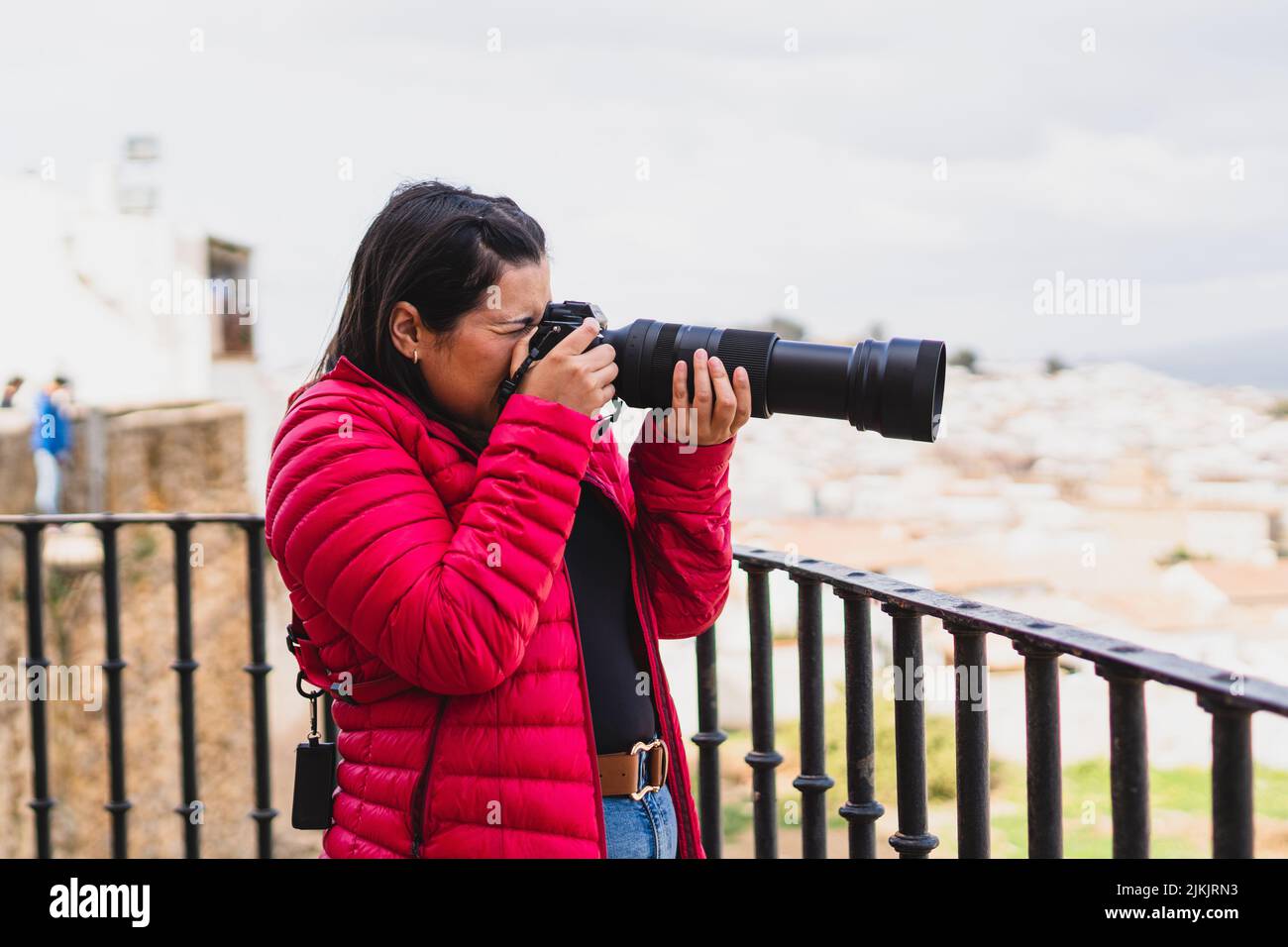A young female taking photos of a view with a professional camera Stock ...