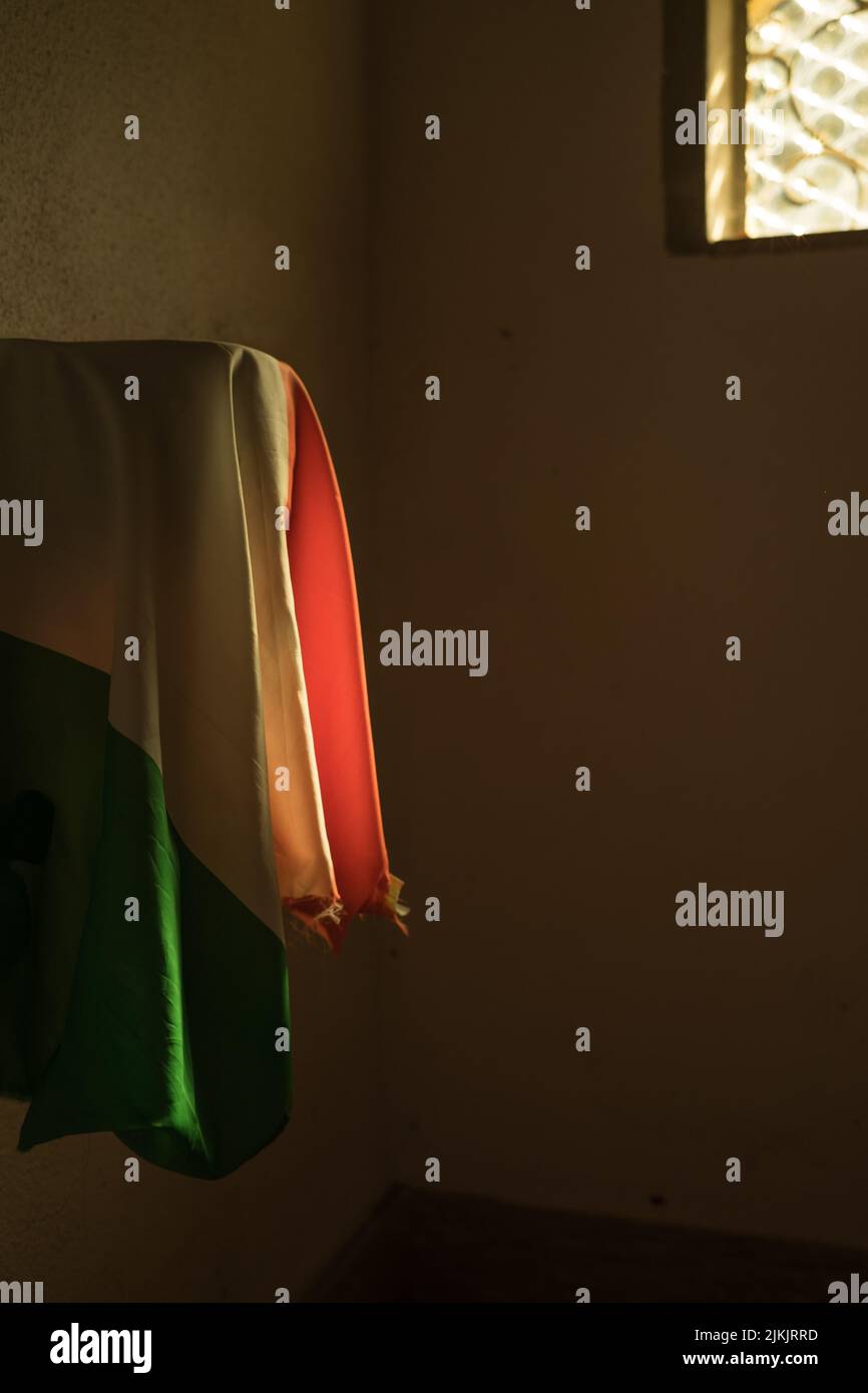 A vertical shot of an Irish flag hanging on a wall handle Stock Photo ...