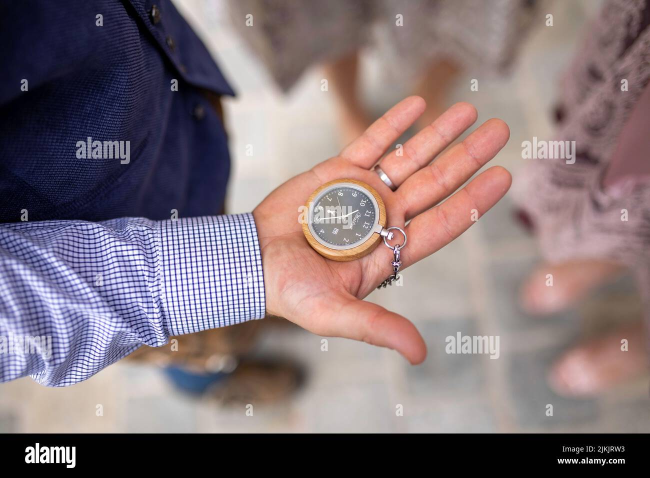 A top view of a vintage pocket watch in a man's hand Stock Photo - Alamy
