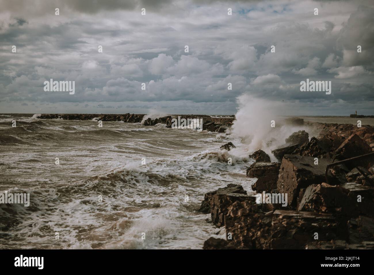A beautiful shot of the bay and the waves hit the rocks on a rainy day ...