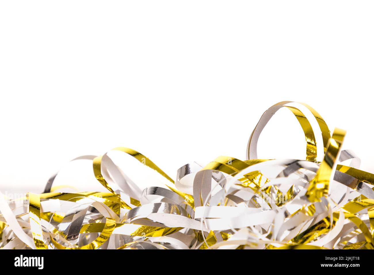 A closeup of gold and silver streamer isolated on a white background ...