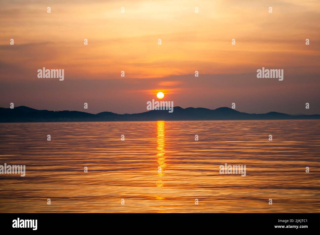 A wallpaper of beautiful golden sunset Stock Photo - Alamy