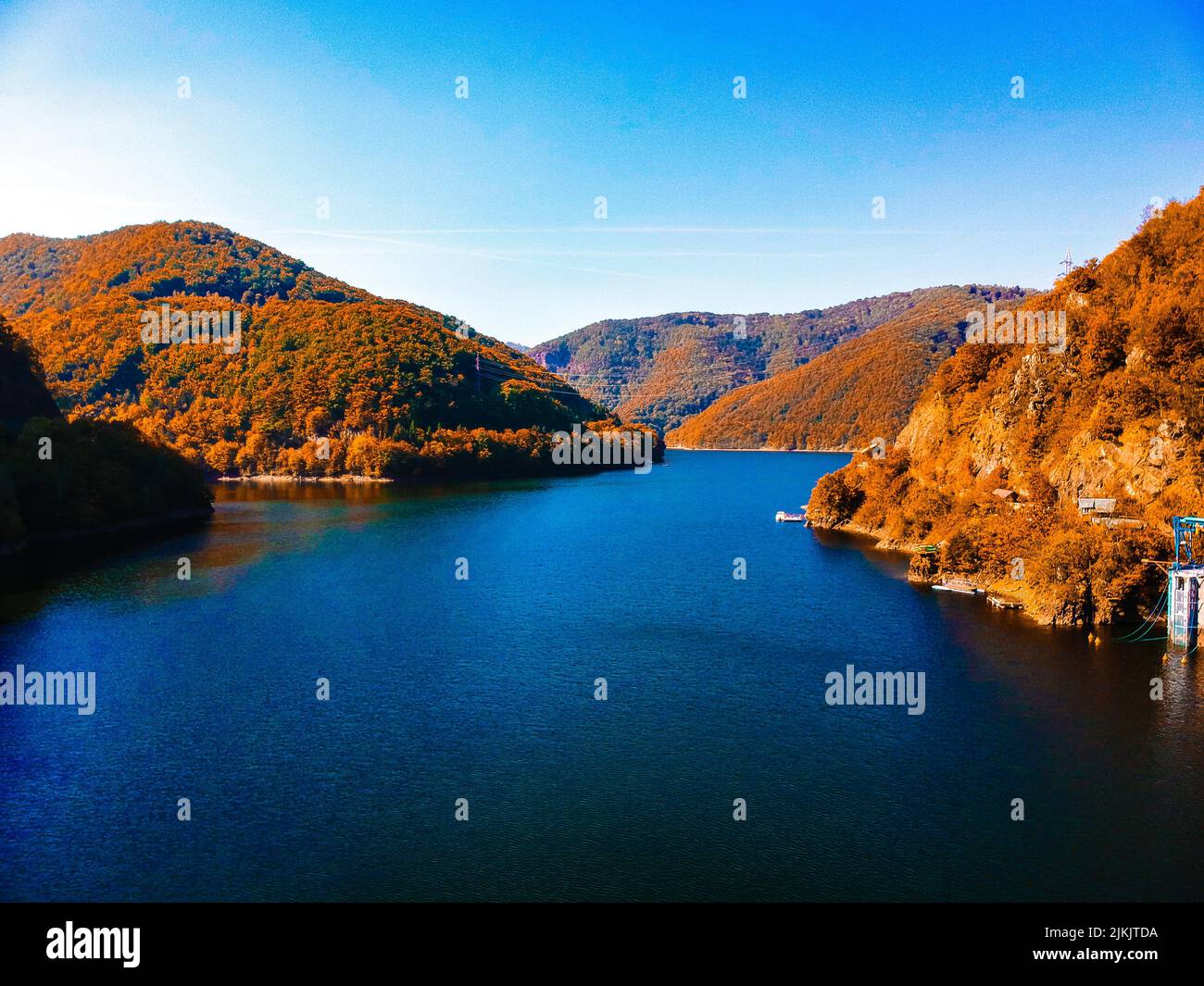 An aerial view of the flowing river surrounded by the green mountains ...
