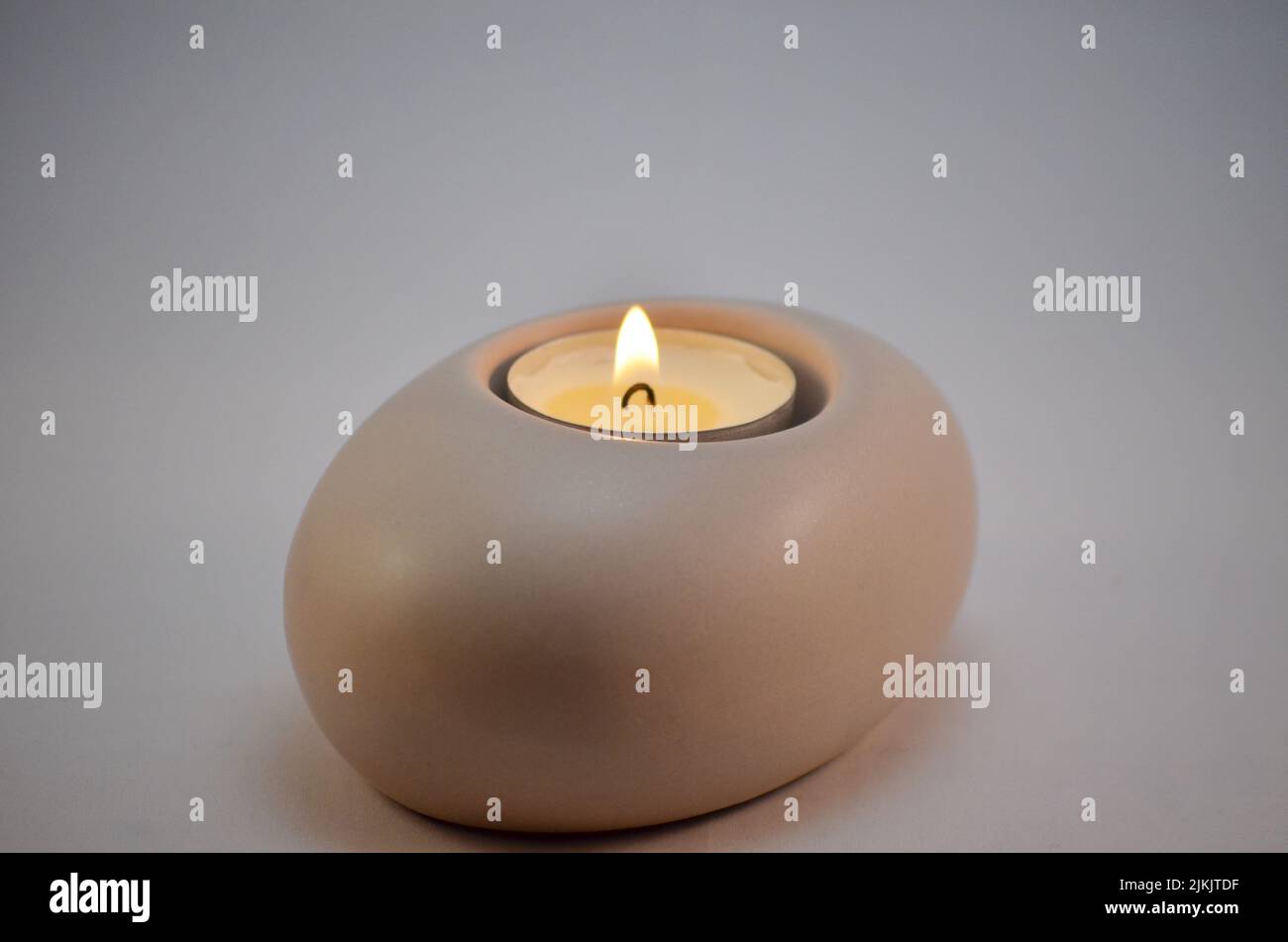 A hollowed-out stone in the burn a small candle Stock Photo - Alamy