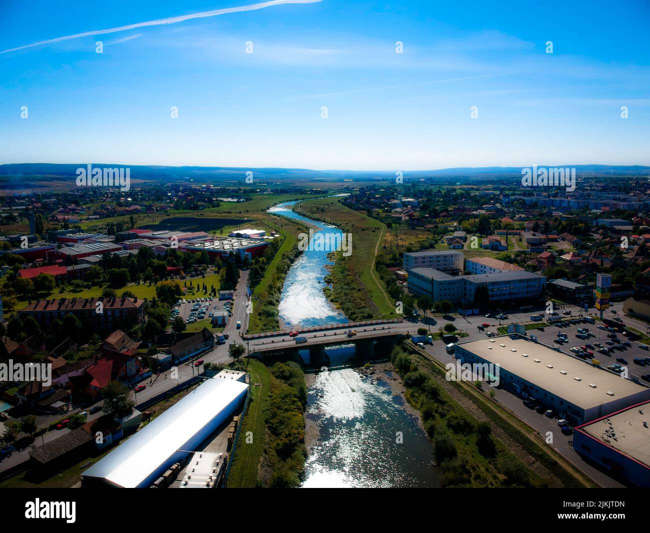 An aerial view of the flowing Danube river under the cloudy blue sky ...