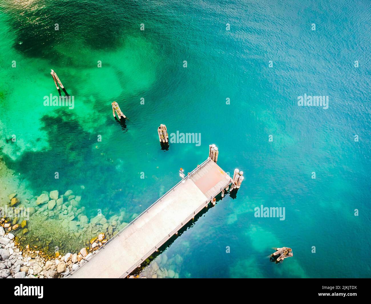 An aerial view of a pier on the coast of the calm sea Stock Photo - Alamy