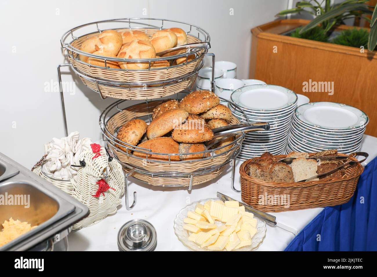 The different kinds of bread, butter, and dishes on a breakfast buffet ...