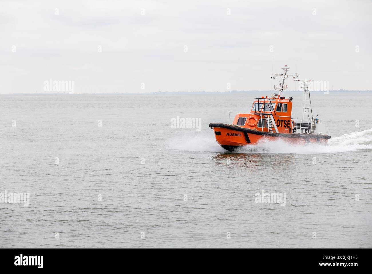 An orange pilot boat sailing on the Elbe River Stock Photo - Alamy