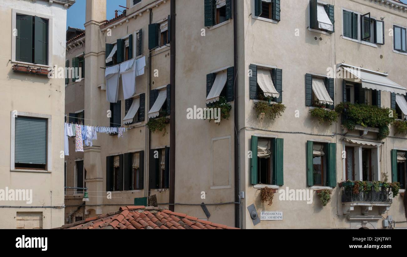 A beautiful view of an apartment building with laundry Stock Photo - Alamy