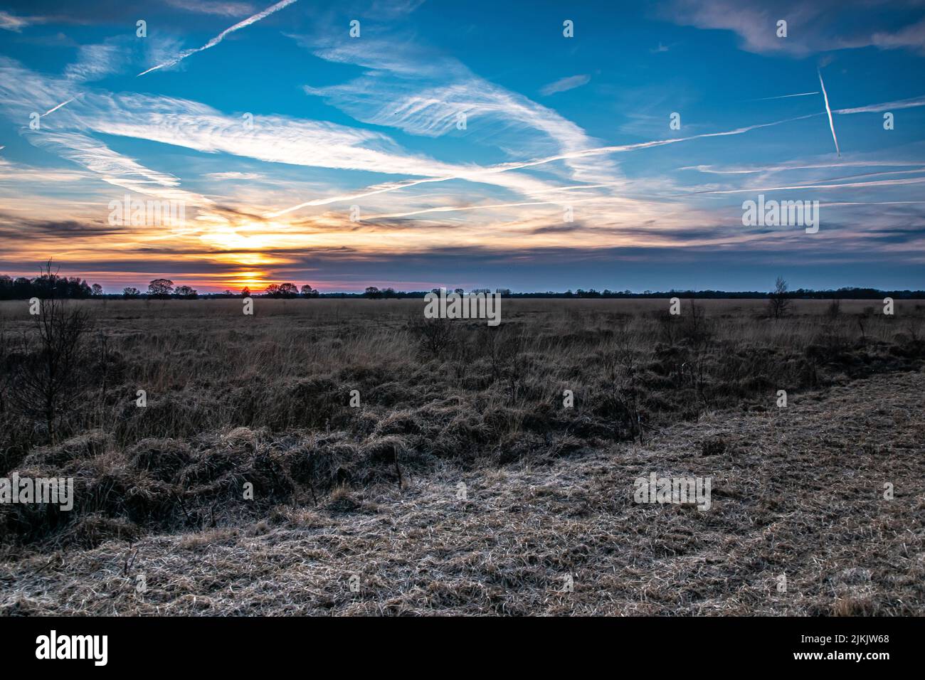 A scenic view of a flat landscape with beautiful clouds at sunset Stock ...