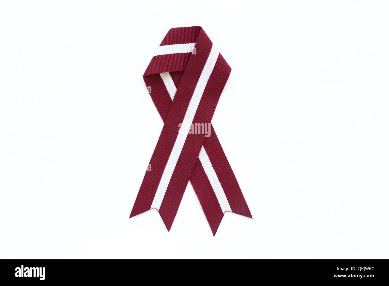 Ribbon in the colours of Latvian flag isolated on a white background ...