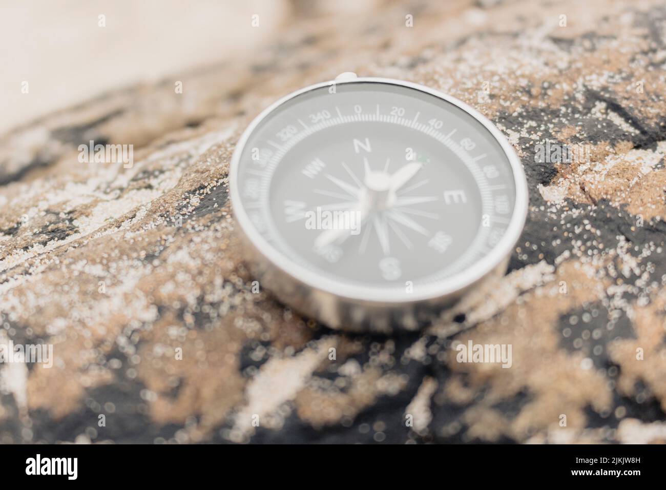 Closeup, analogical compass on a rock, concept orientation, summer ...