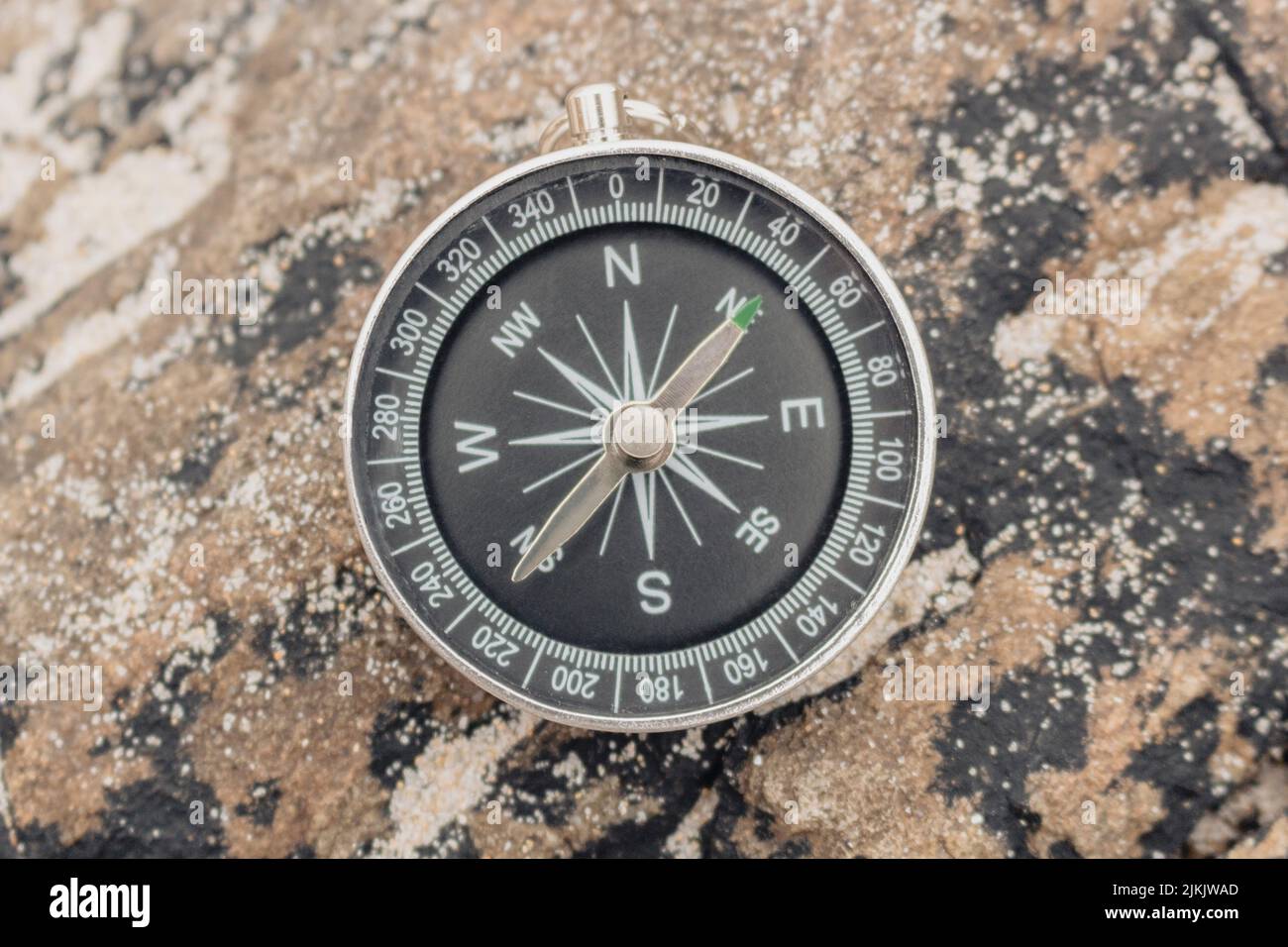 Closeup, analogical compass on a rock, concept orientation, summer ...