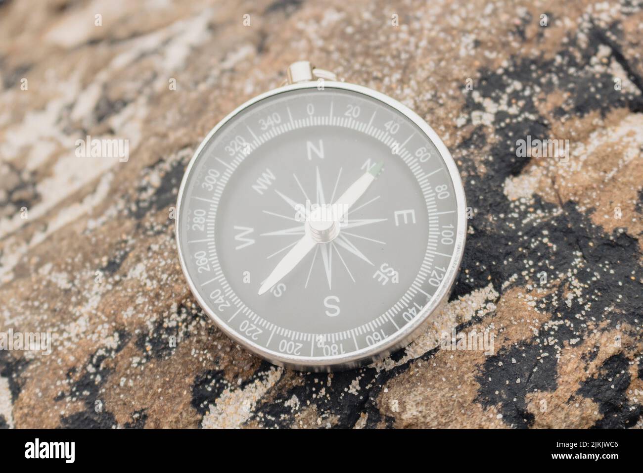 Closeup, analogical compass on a rock, concept orientation, summer ...
