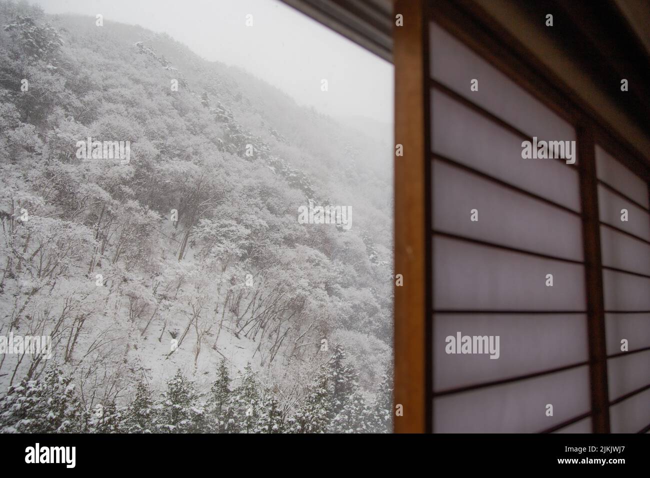The view of snowy mountains seen from the window Stock Photo - Alamy