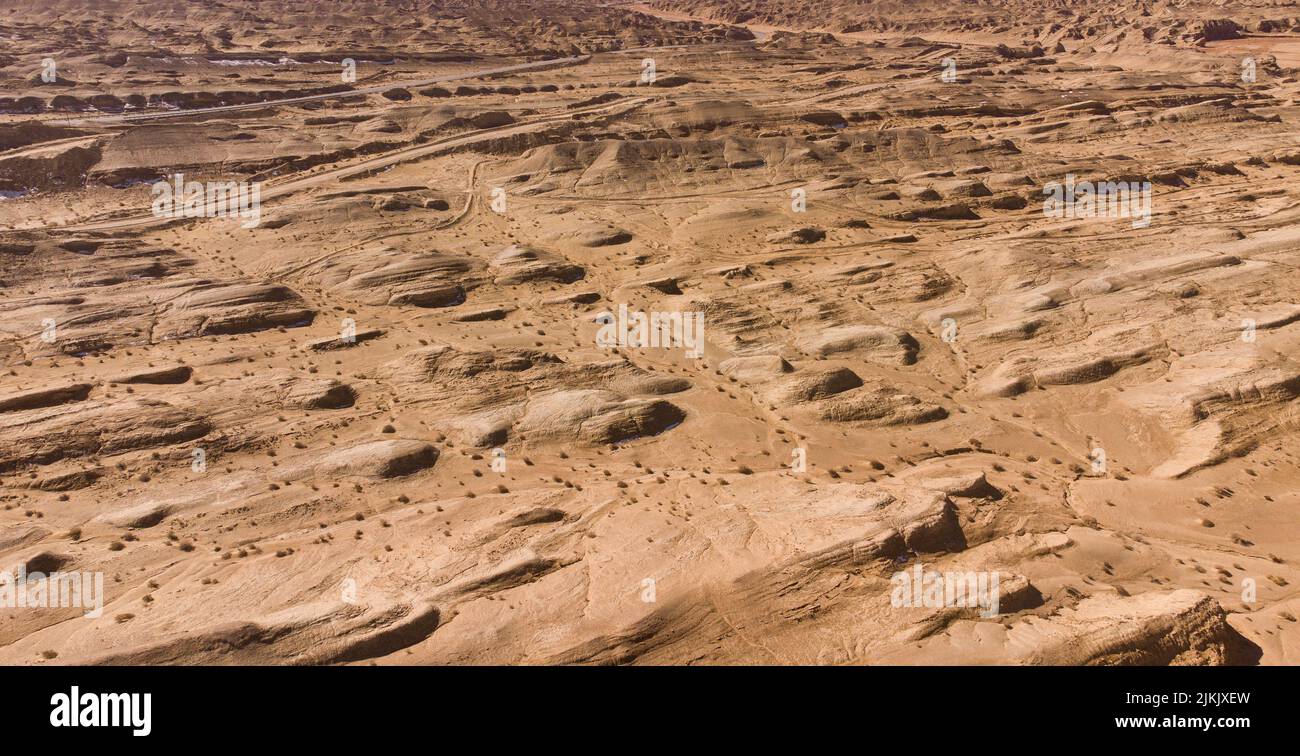 An aerial shot of a desert full of yardangs in daylight Stock Photo - Alamy