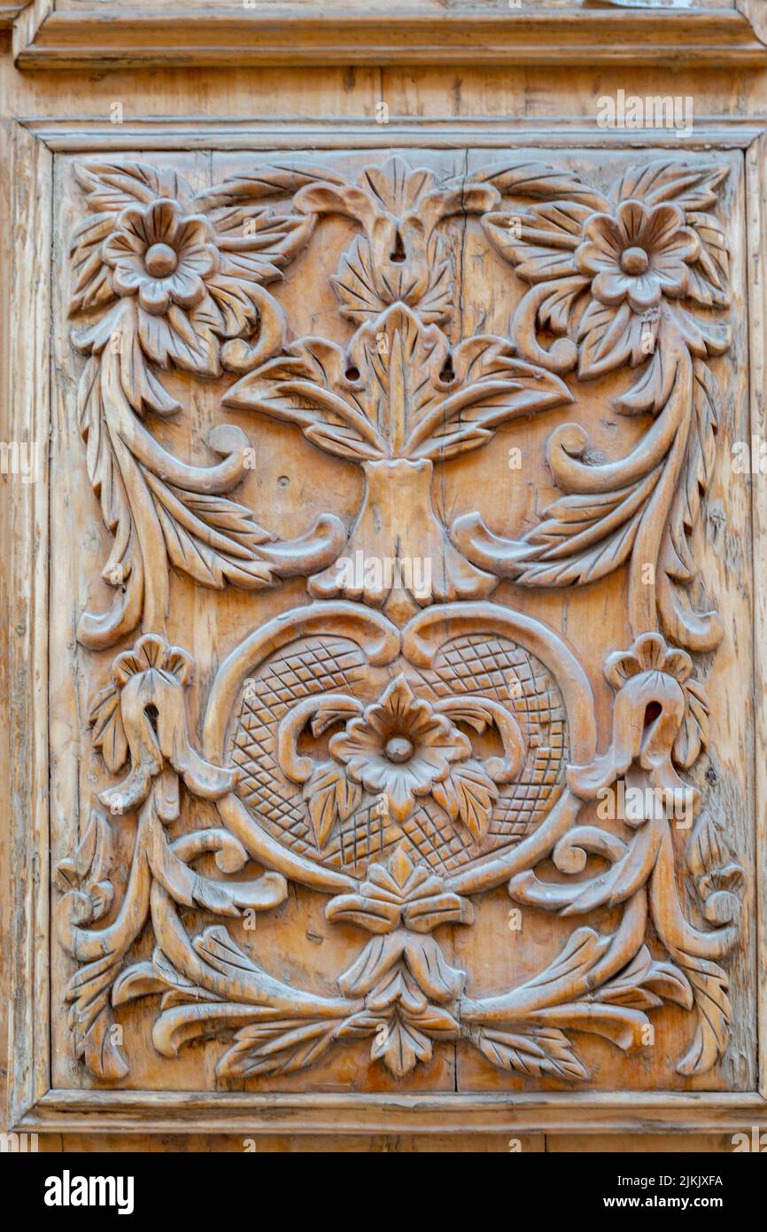 A vertical shot of carved wood with a bas-relief ornament Stock Photo ...