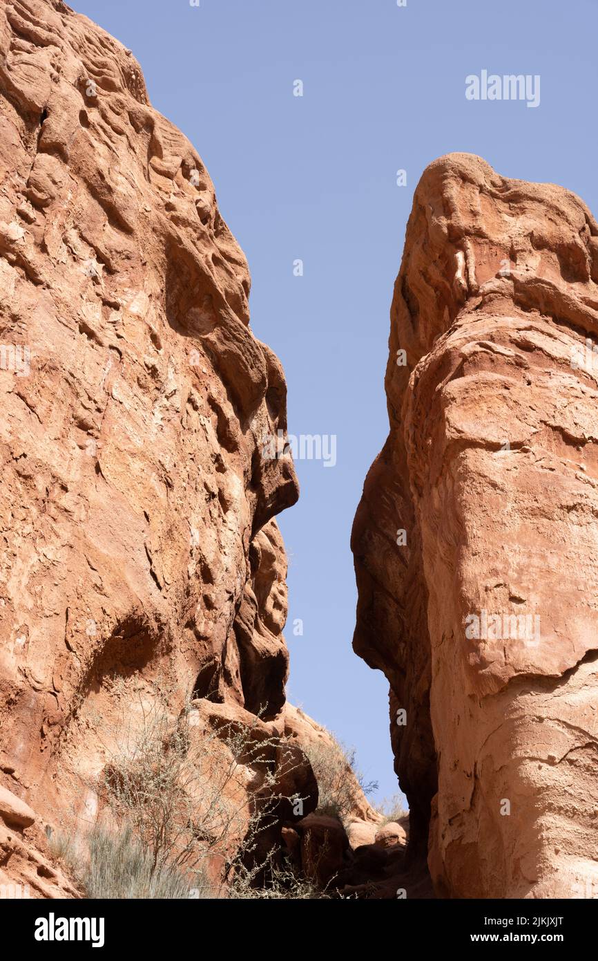 A vertical low angle shot of two tall cliffs in daylight Stock Photo ...