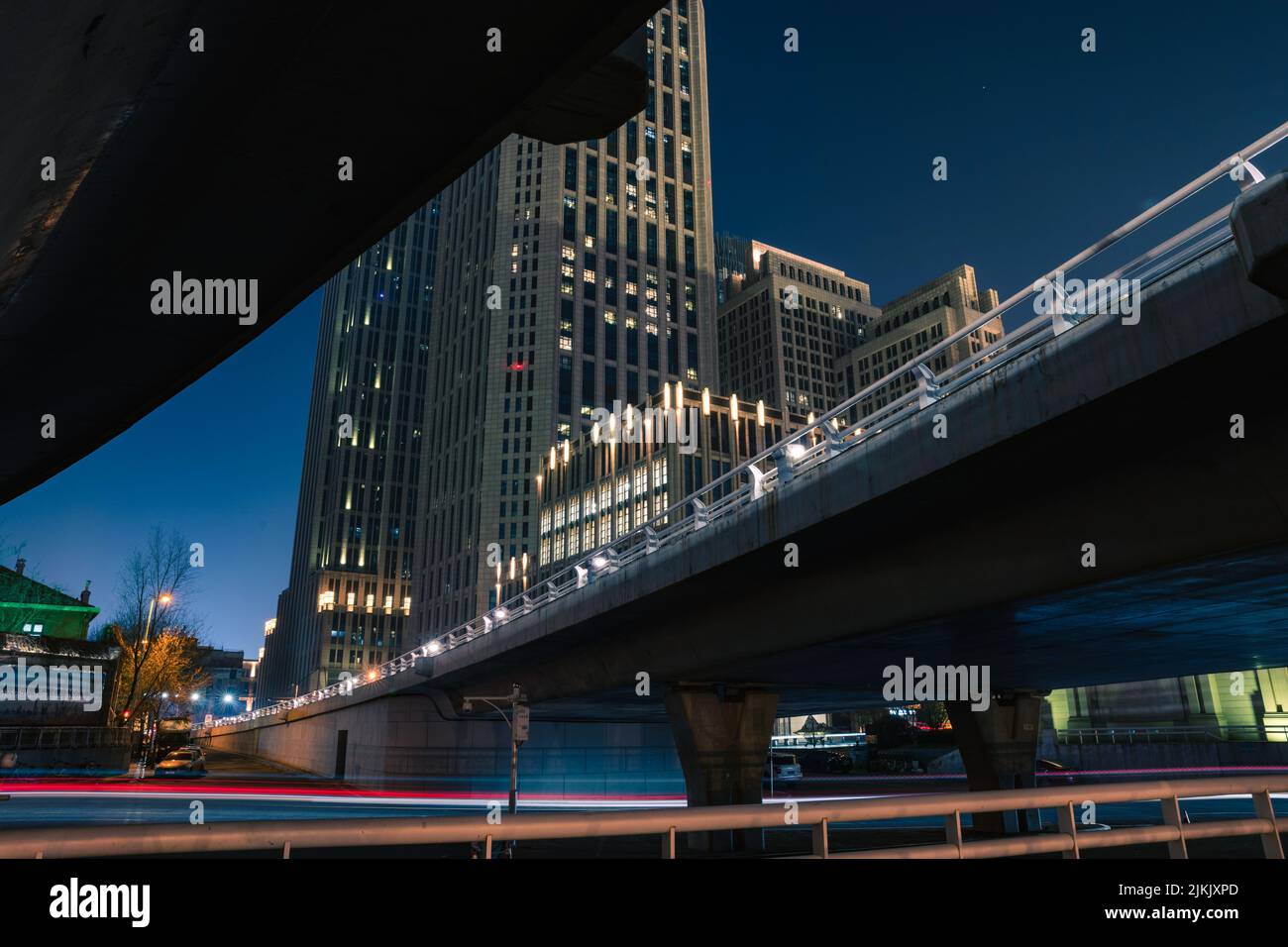 A scenic view of a bridge with highrise buildings and a skyscraper at ...