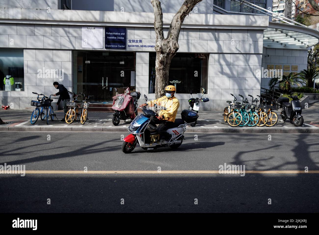 A courier on a motorbike delivering supplies during the Covid 19 ...