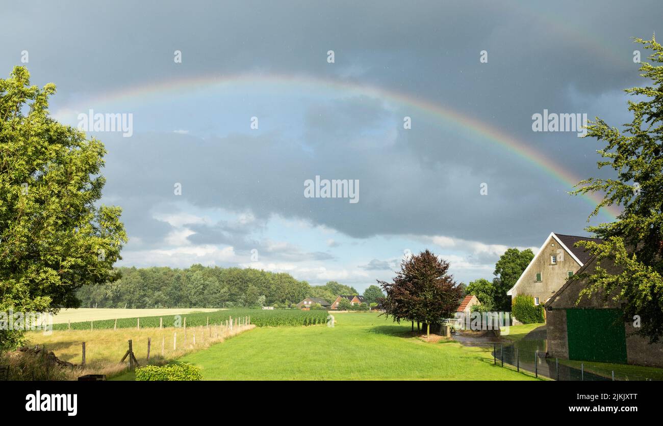 colorful rainbow in the sky with house Stock Photo - Alamy