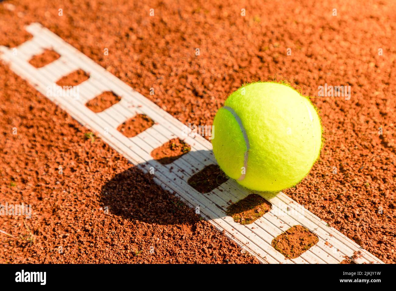 tennis ball with line on a sand court Stock Photo - Alamy