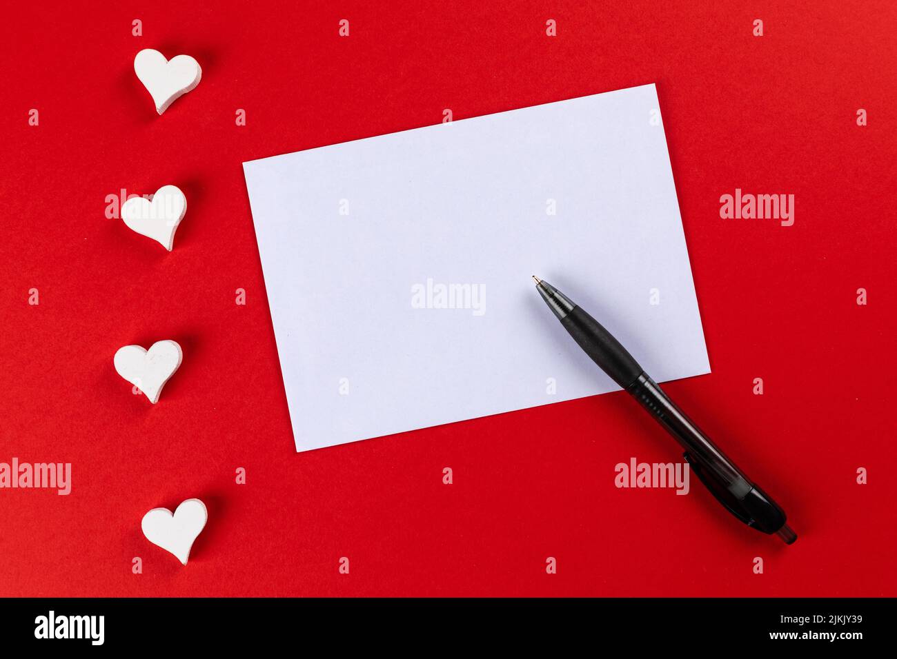 top view with red background with hearts for writing a love letter for ...