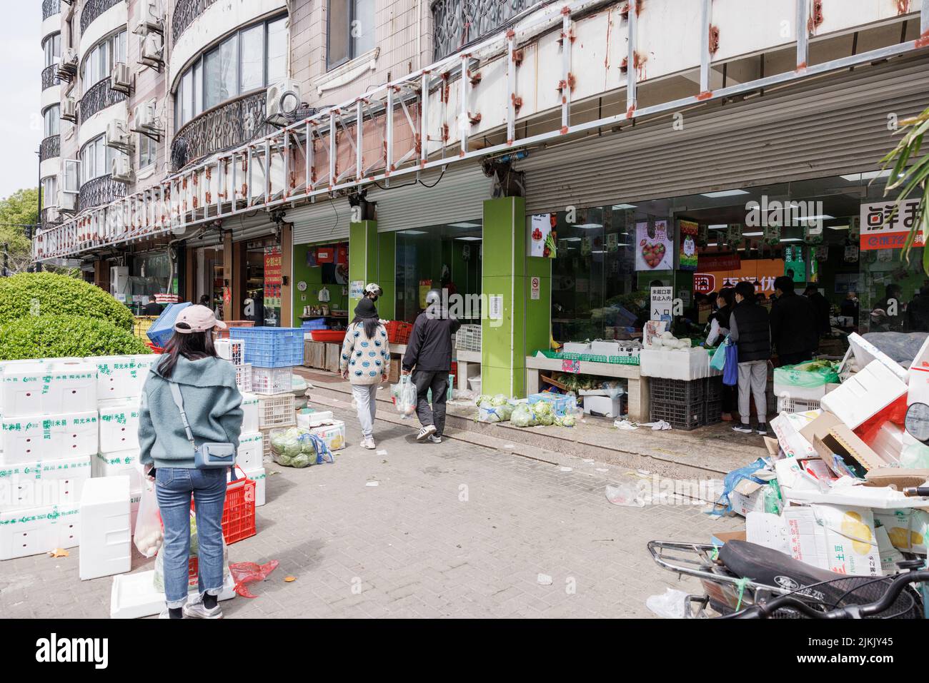 A group of people at a supermarket shopping for essentials in ...