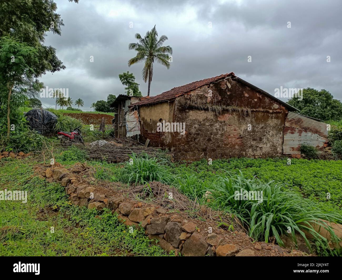 Stock photo of old, damaged red brick house with pyramid shape roof top ...