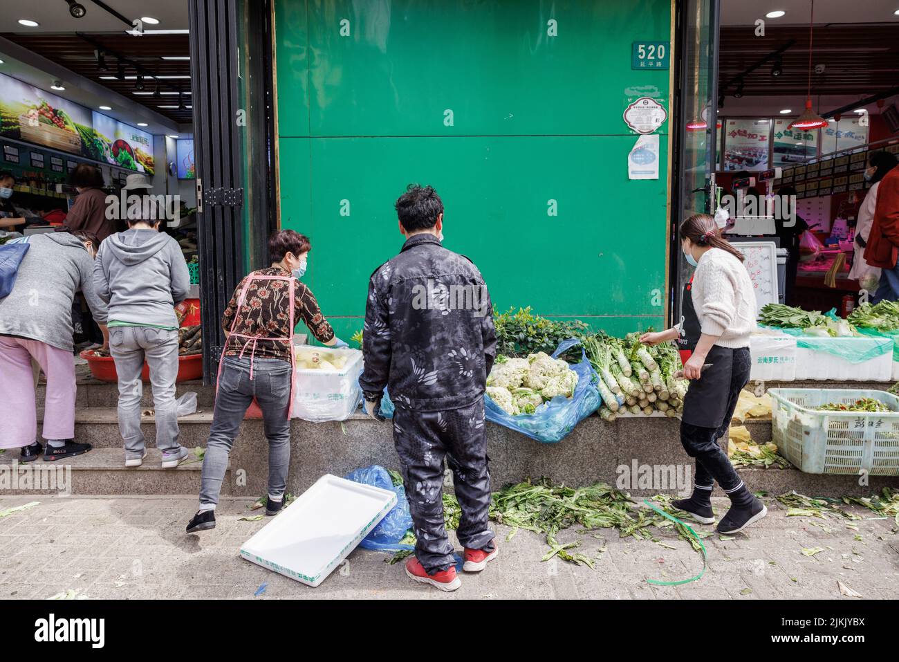 A group of people in a supermarket shopping for essentials in ...