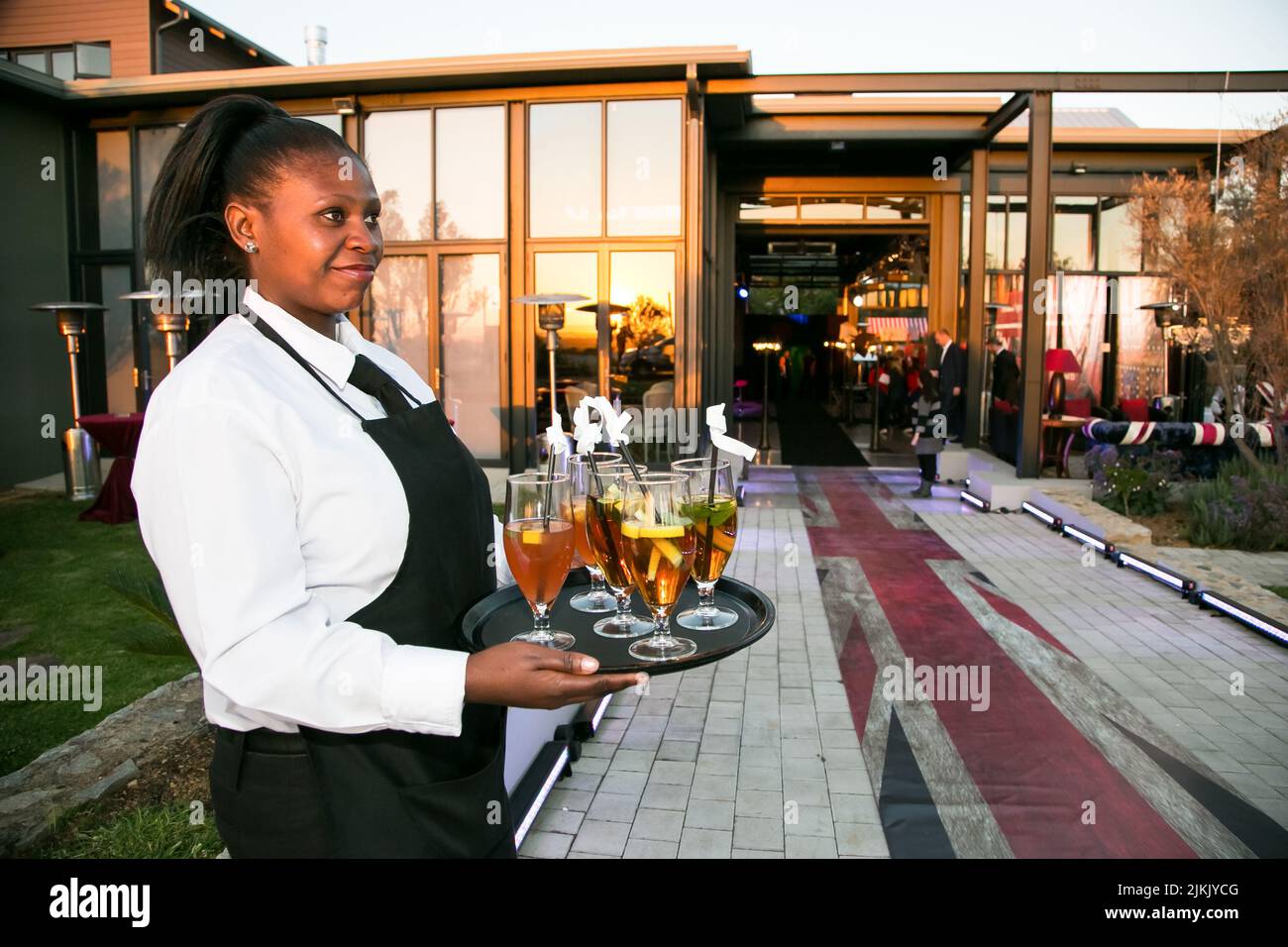 Johannesburg, South Africa - May 5, 2015: African waitress holding a ...