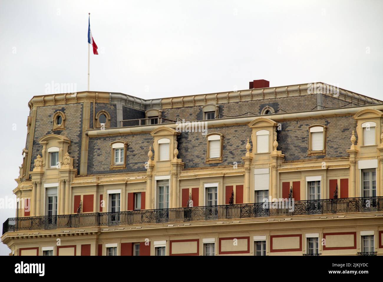 A beautiful view of an old building with a flag on the rooftop in ...