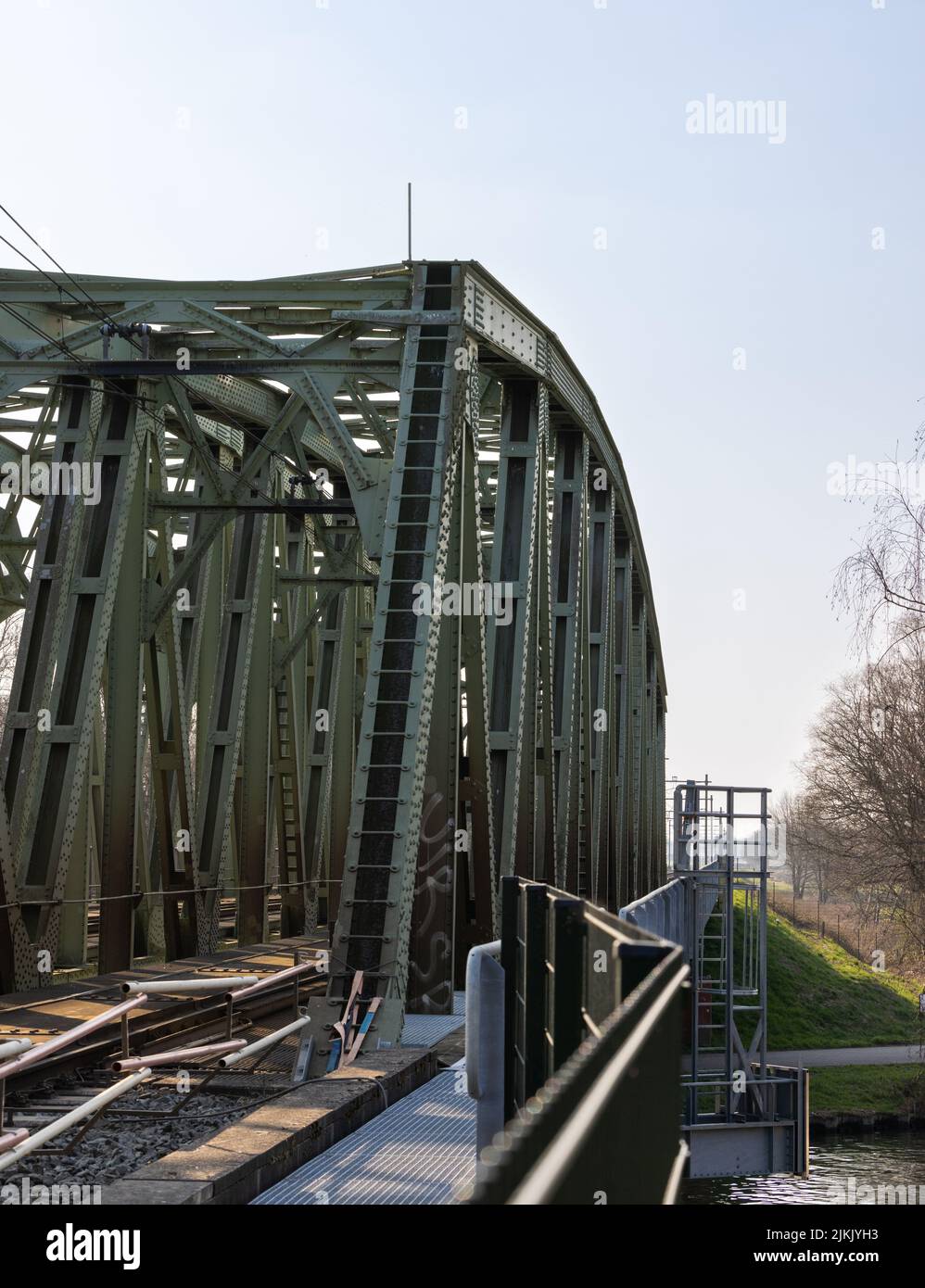A vertical shot of a train bridge over a river in the Netherlands going ...