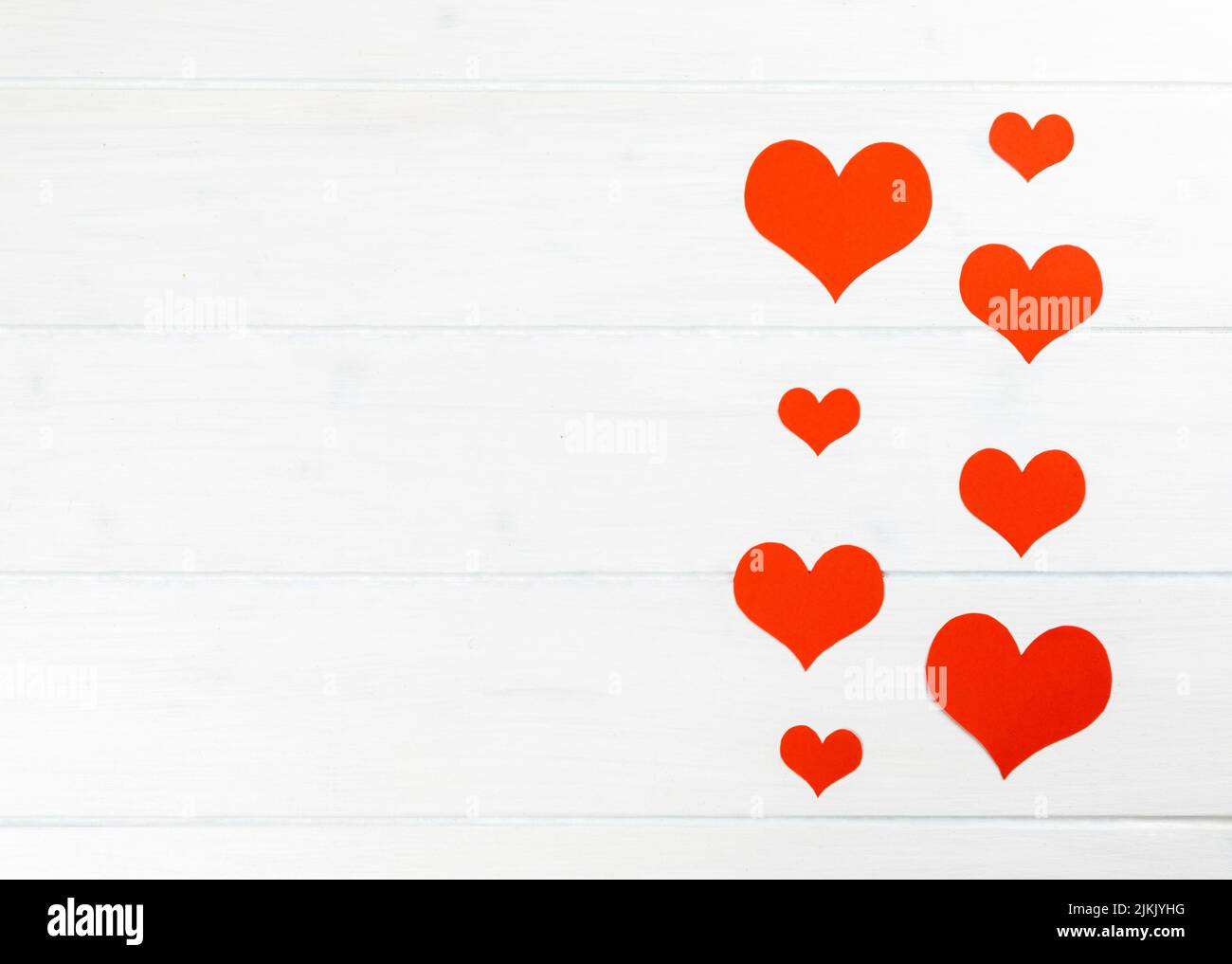 red hearts on a white wooden background frame Stock Photo - Alamy