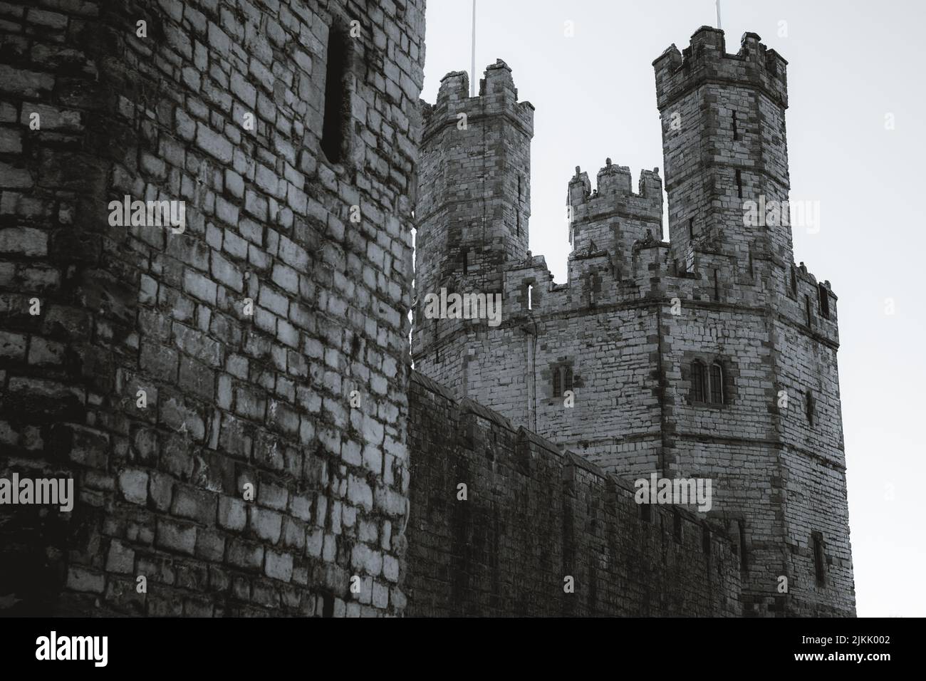 A grayscale shot of the Caernarfon Castle (Welsh: Castell Caernarfon ...