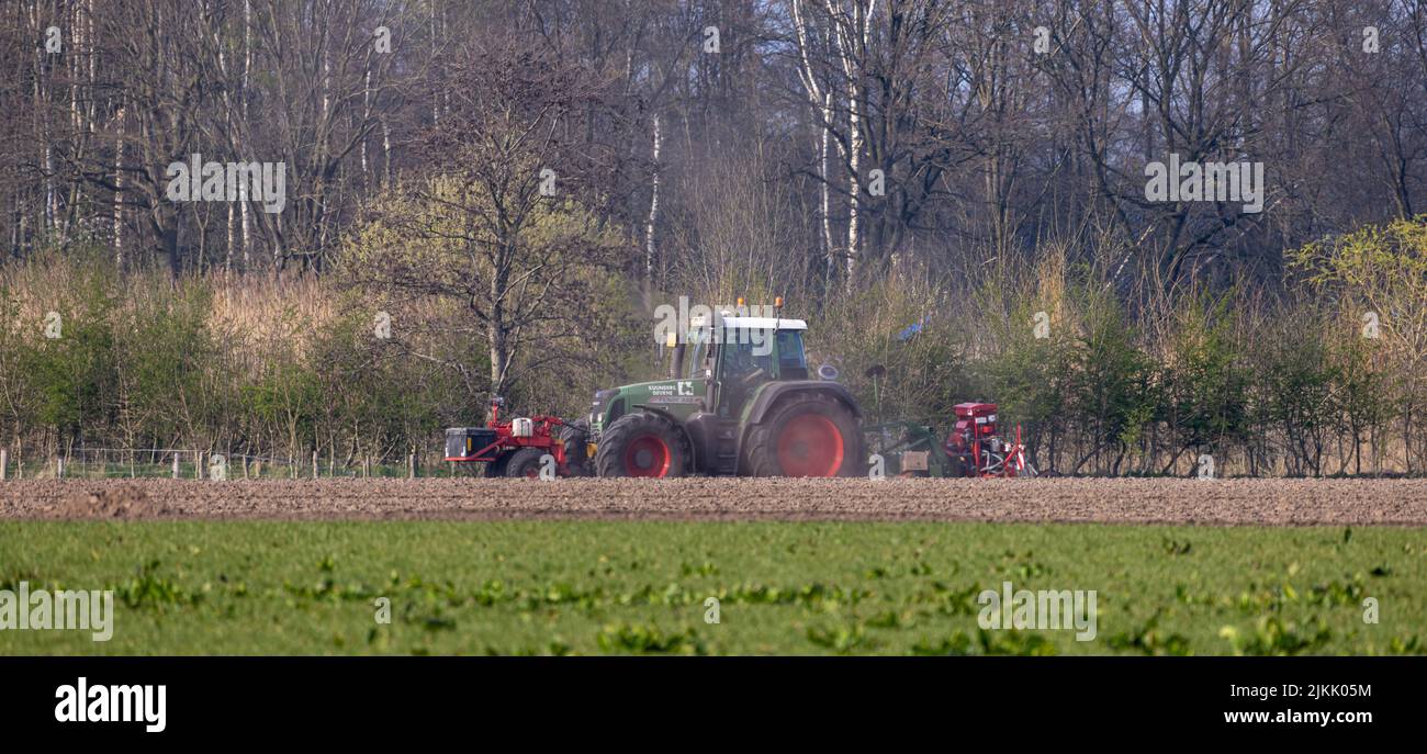 A Fendt tractor plowing through the field in Nederweert, the ...