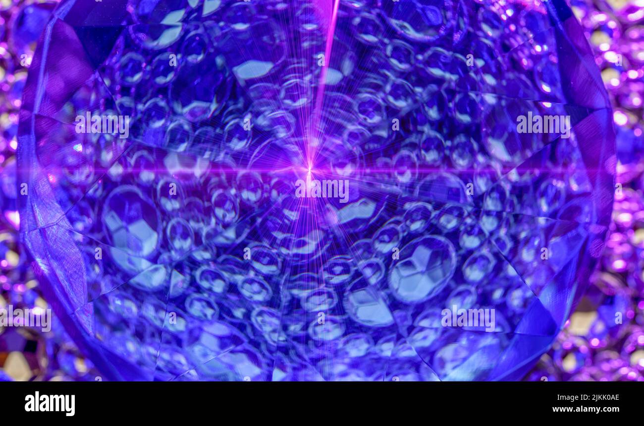 An illustration of blue diamond shapes with purple sparkle at the ...