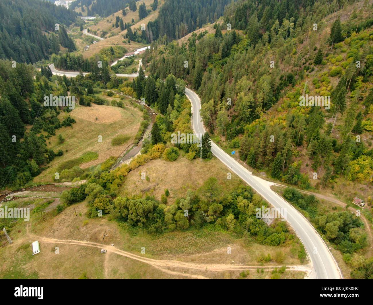 An aerial view of forest fields and highway in Asenovgrad, Bulgaria ...