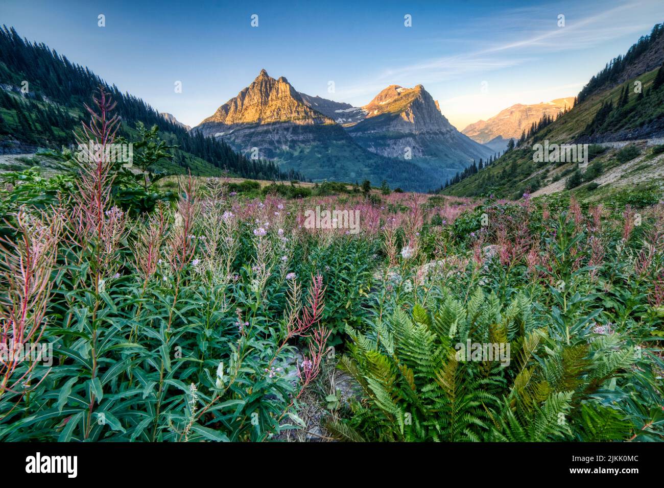 A photo of the sun hitting the mountain peaks in Glacier National Park ...