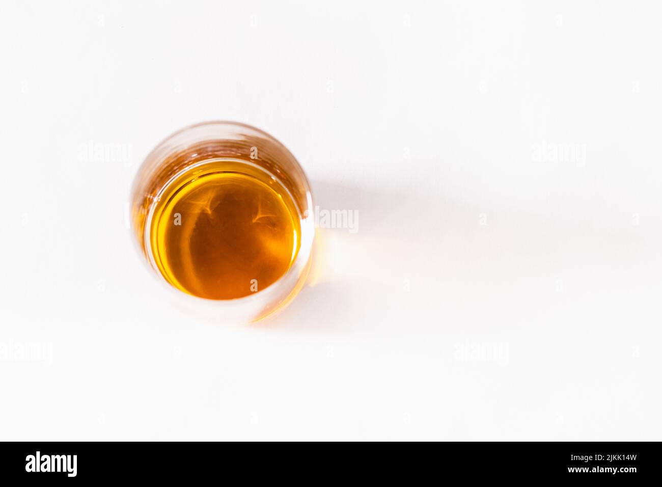 A top view closeup of a brown liquid in a transparent glass isolated on ...