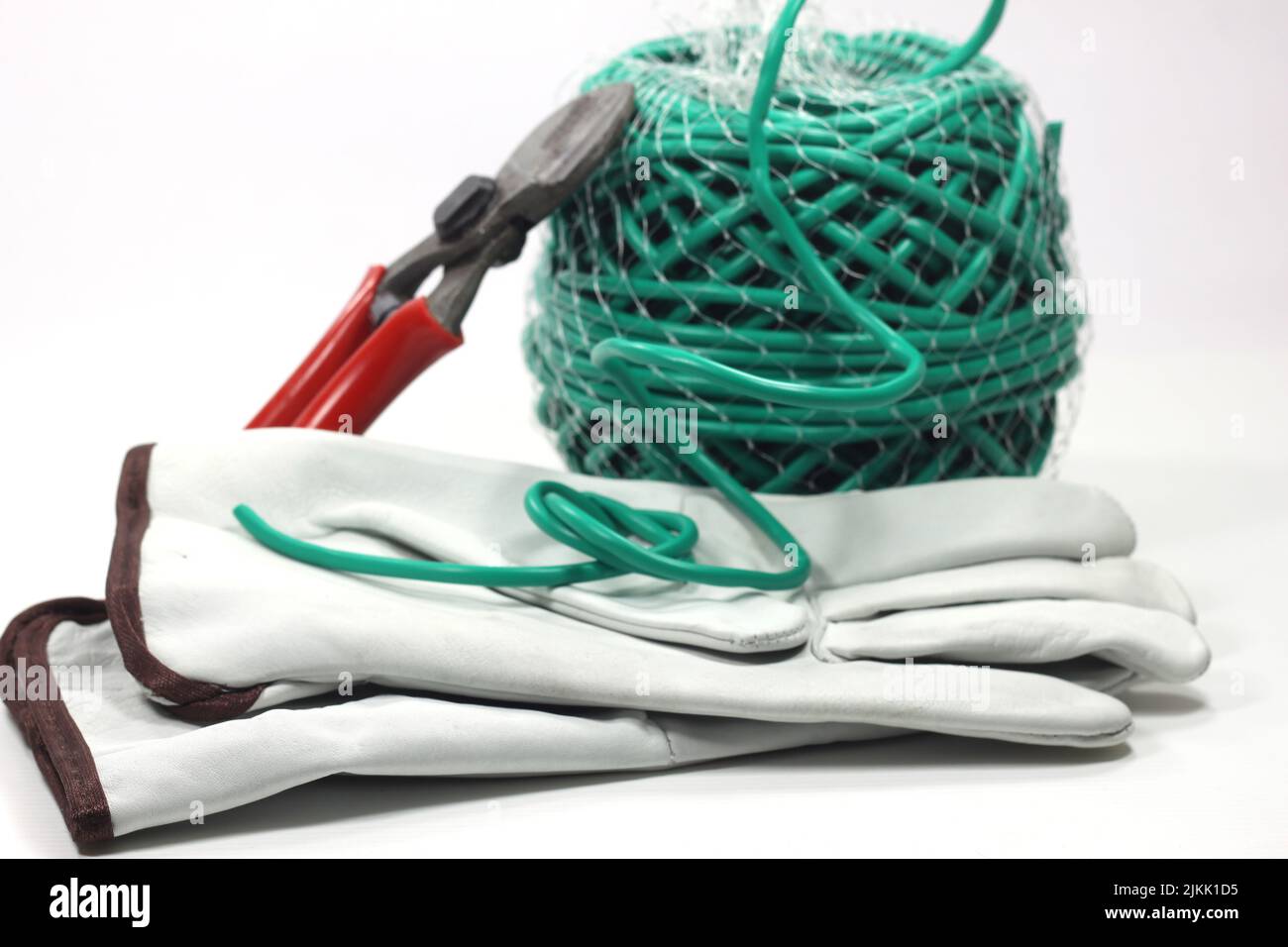 leather work gloves, plasticized rope and agricultural scissors Stock ...