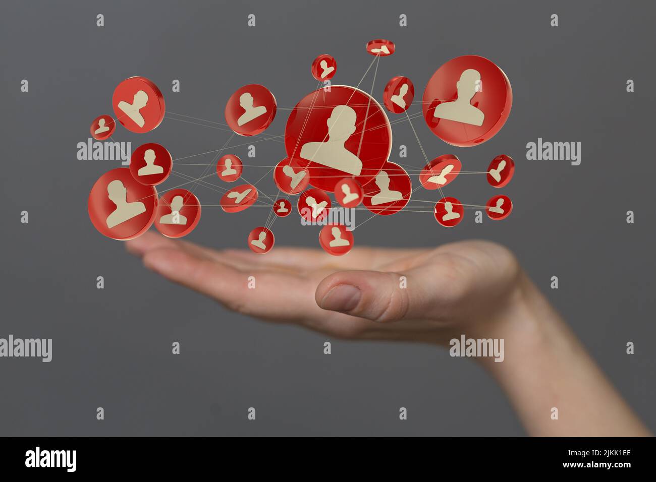 photo of the hand over which fly red person icons Stock Photo - Alamy