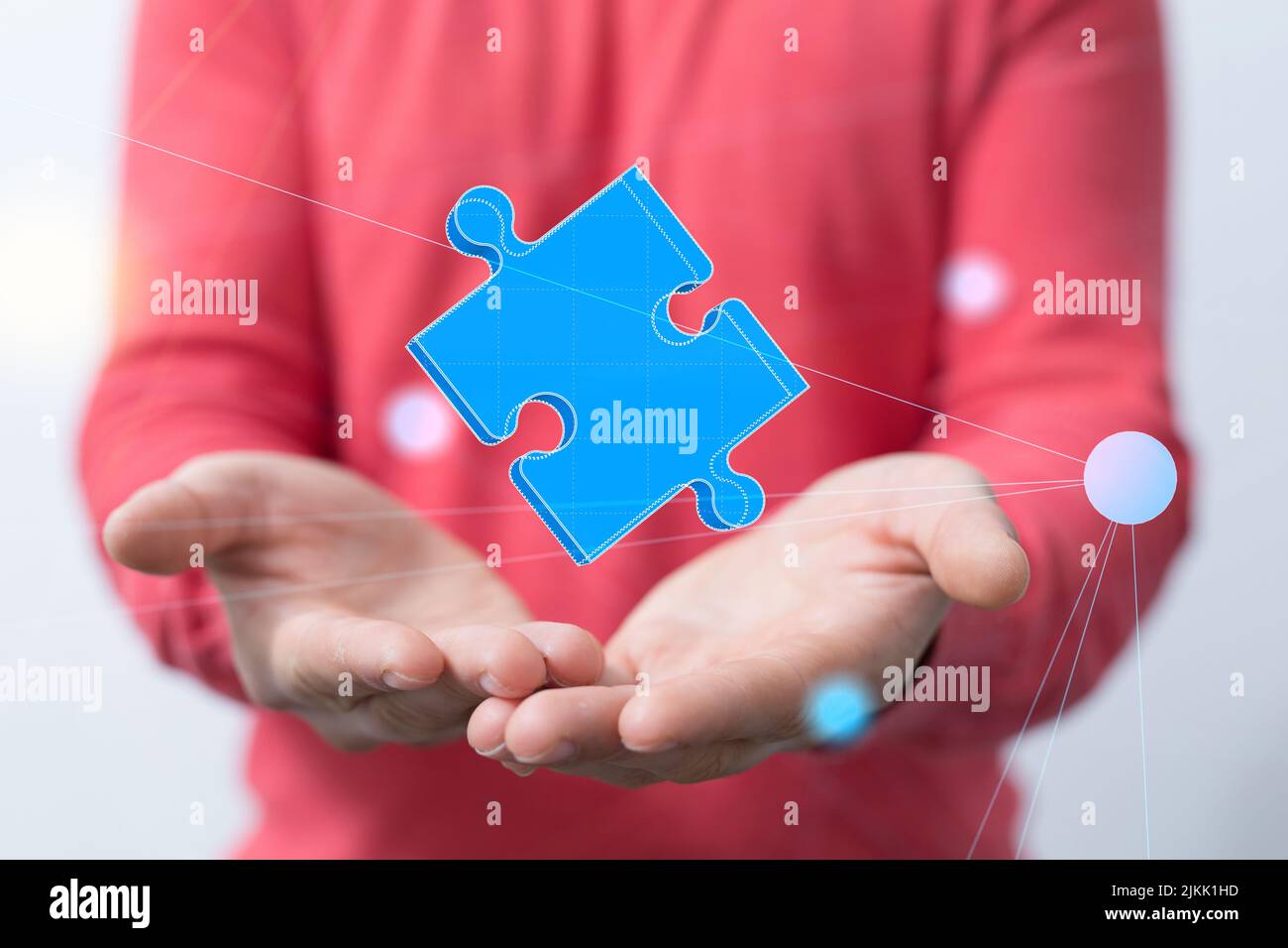 A 3D rendering of a blue puzzle in a hand, the concept for business ...