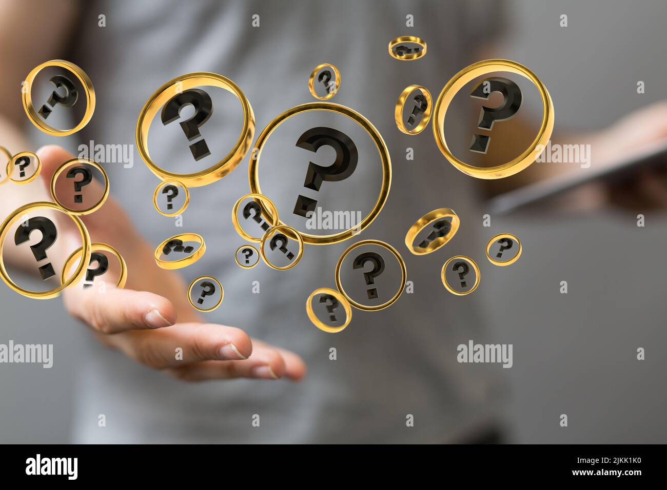 A question mark icon floating in the palm of a man in gray shirt Stock Photo - Alamy