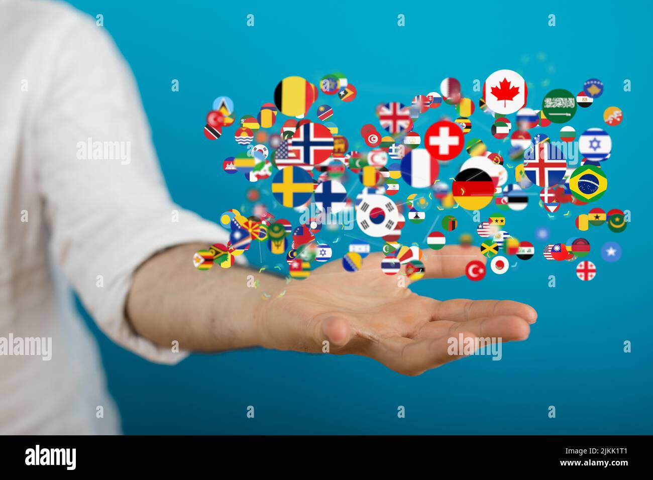 A hand holding illustrated international country flags Stock Photo - Alamy
