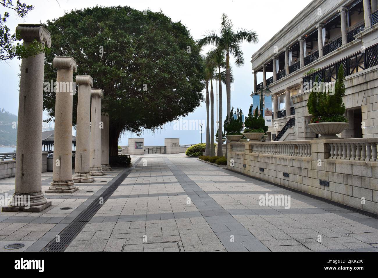 A scenic view of green trees and stone columns against the Murray House ...