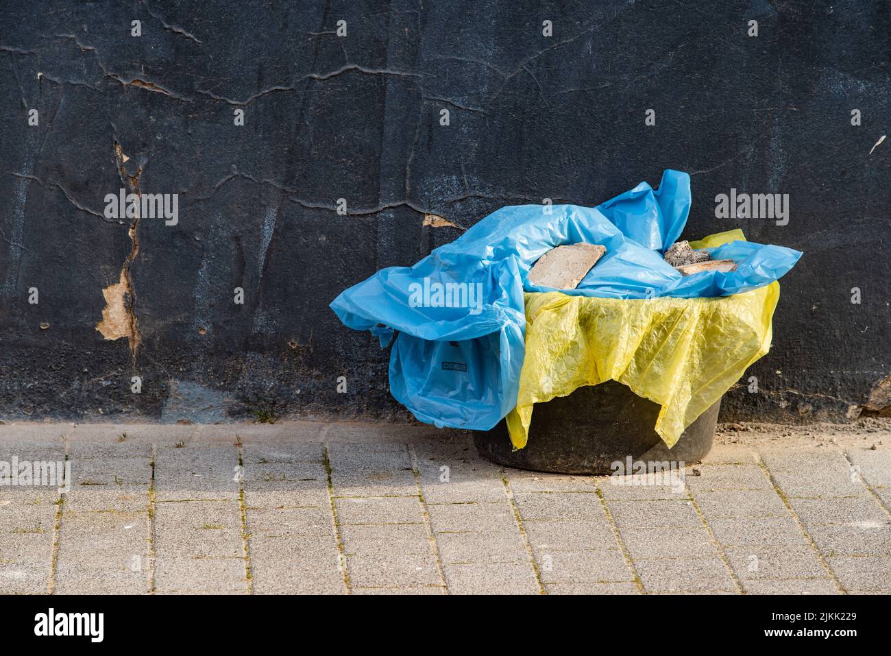 An old trash can with garbage and used mesh bags Stock Photo - Alamy