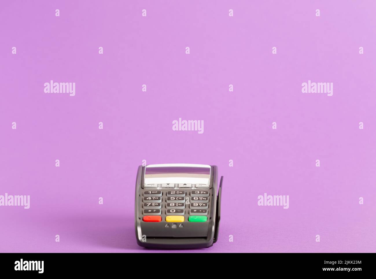 A wireless POS machine on a purple background Stock Photo - Alamy