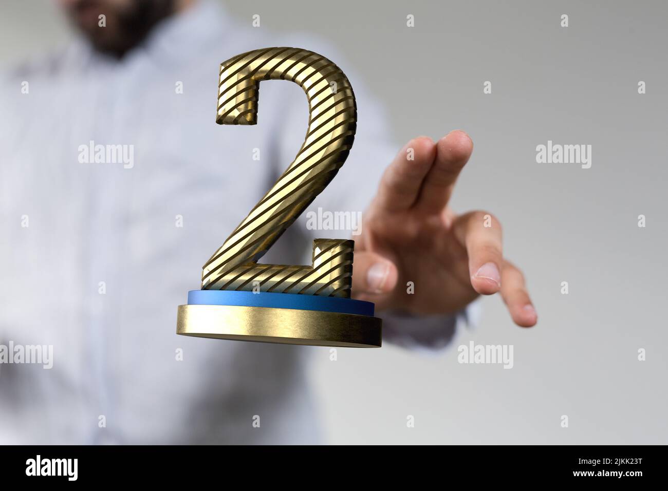 A person presenting the virtual projection of a second place award ...