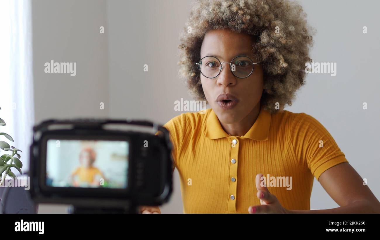 A selective focus of an African lady talking in front of the camera ...
